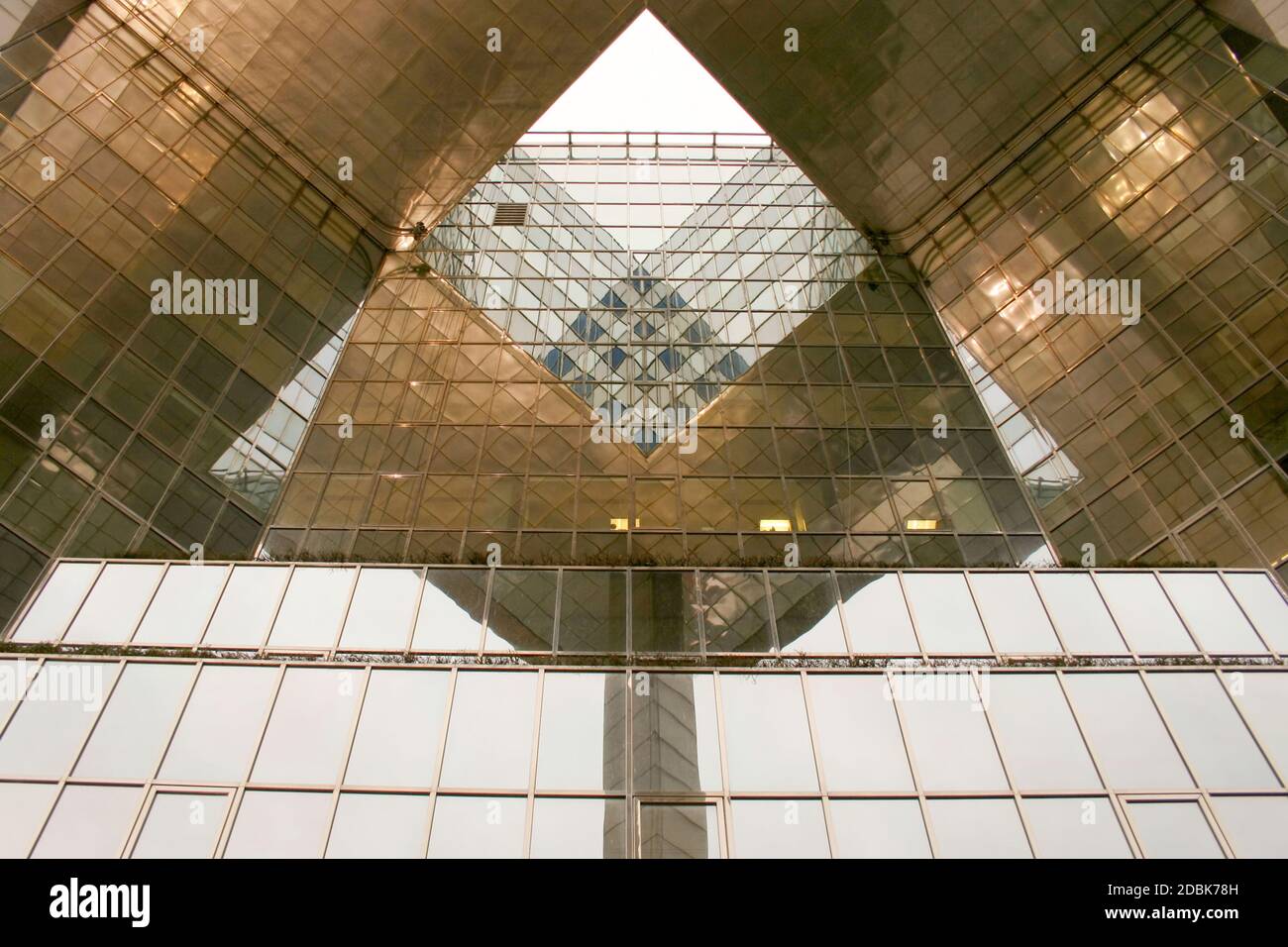 Triangular building structure with front glass facade Stock Photo - Alamy
