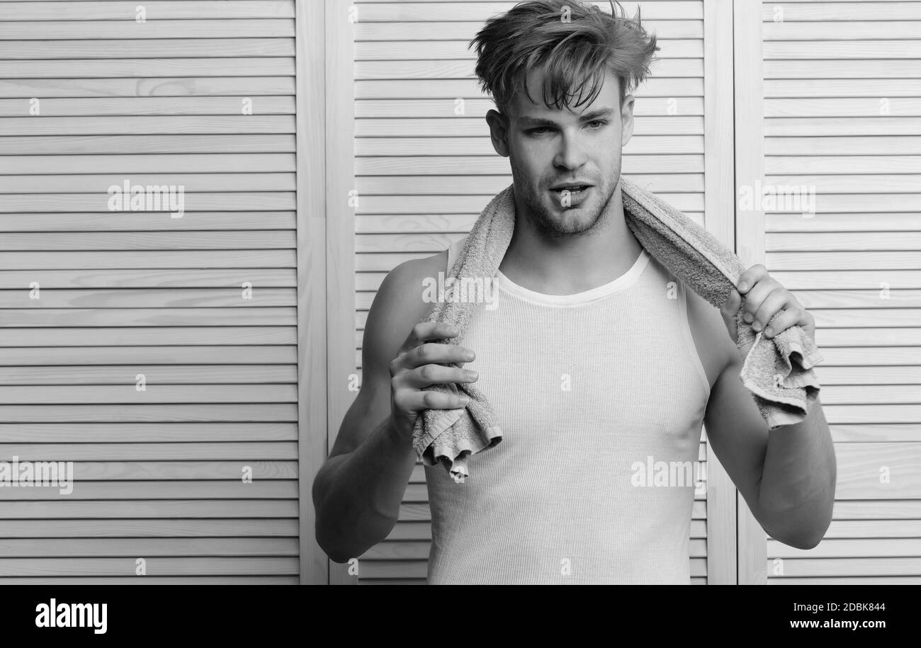 Guy with messy hair and questioning face on wooden door background ...