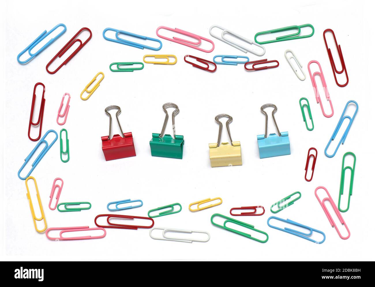 Colorful metal paper clips and pins stationery arranged in square on ...