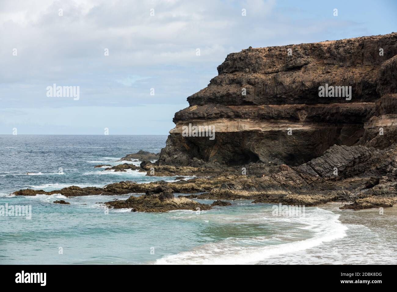 Wave splashing over a rock on the beach of Puertito de los Molinos on ...