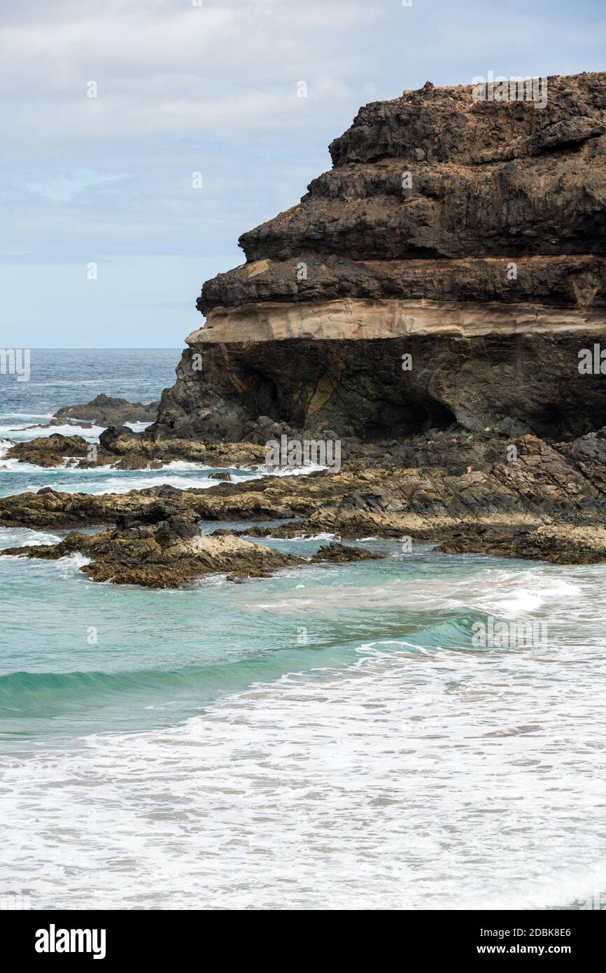 Wave splashing over a rock on the beach of Puertito de los Molinos on ...