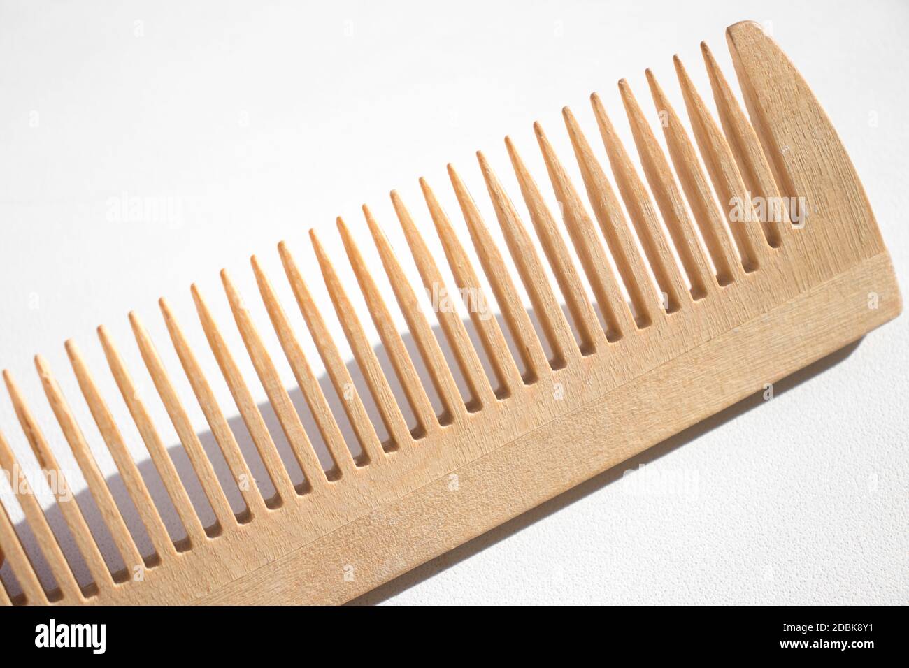 Thin comb of light wood on a white background Stock Photo - Alamy