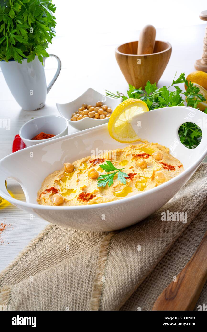 hummus paste with lemon and chilli on white background Stock Photo - Alamy