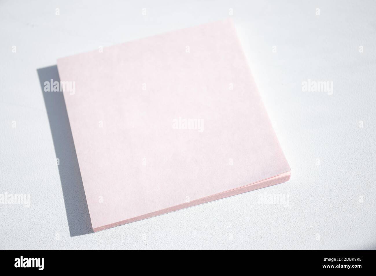 Pink paper sheets for notes on white background Stock Photo - Alamy