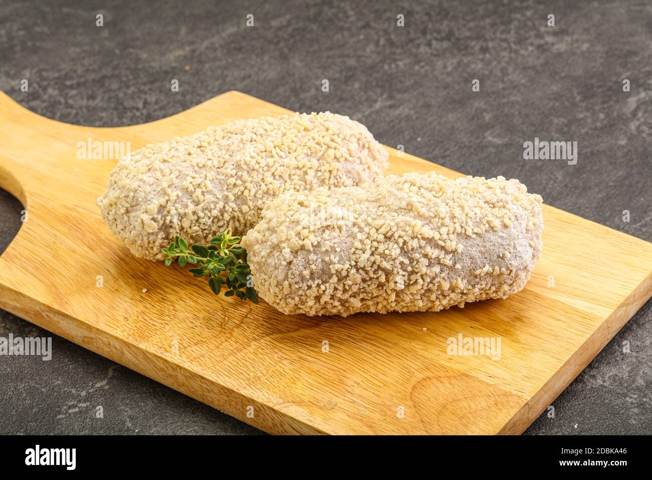 Raw breaded chicken cutlet for roast Stock Photo - Alamy