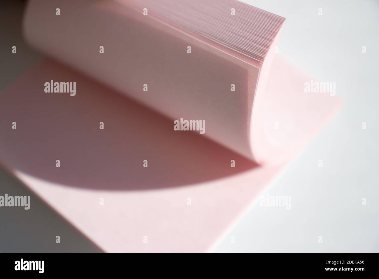 Pink paper sheets for notes on white background Stock Photo - Alamy