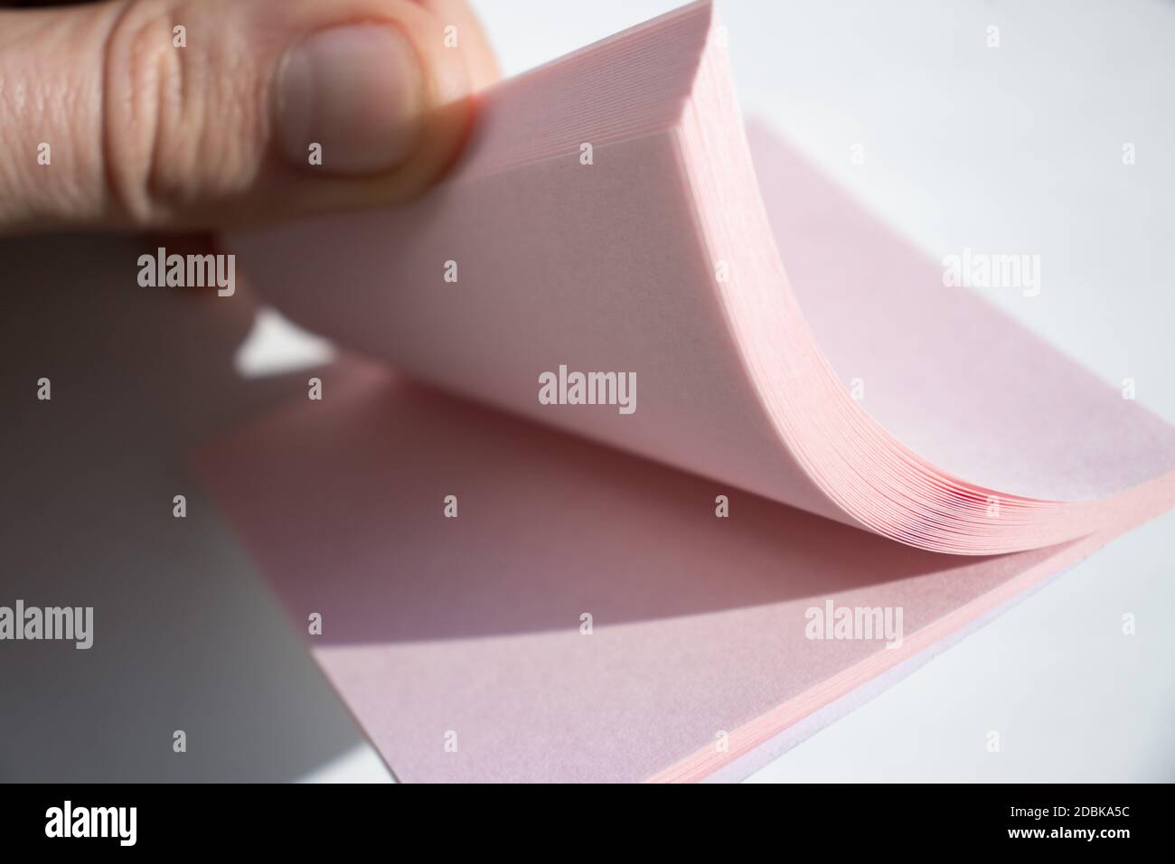 Pink paper sheets for notes on white background Stock Photo - Alamy