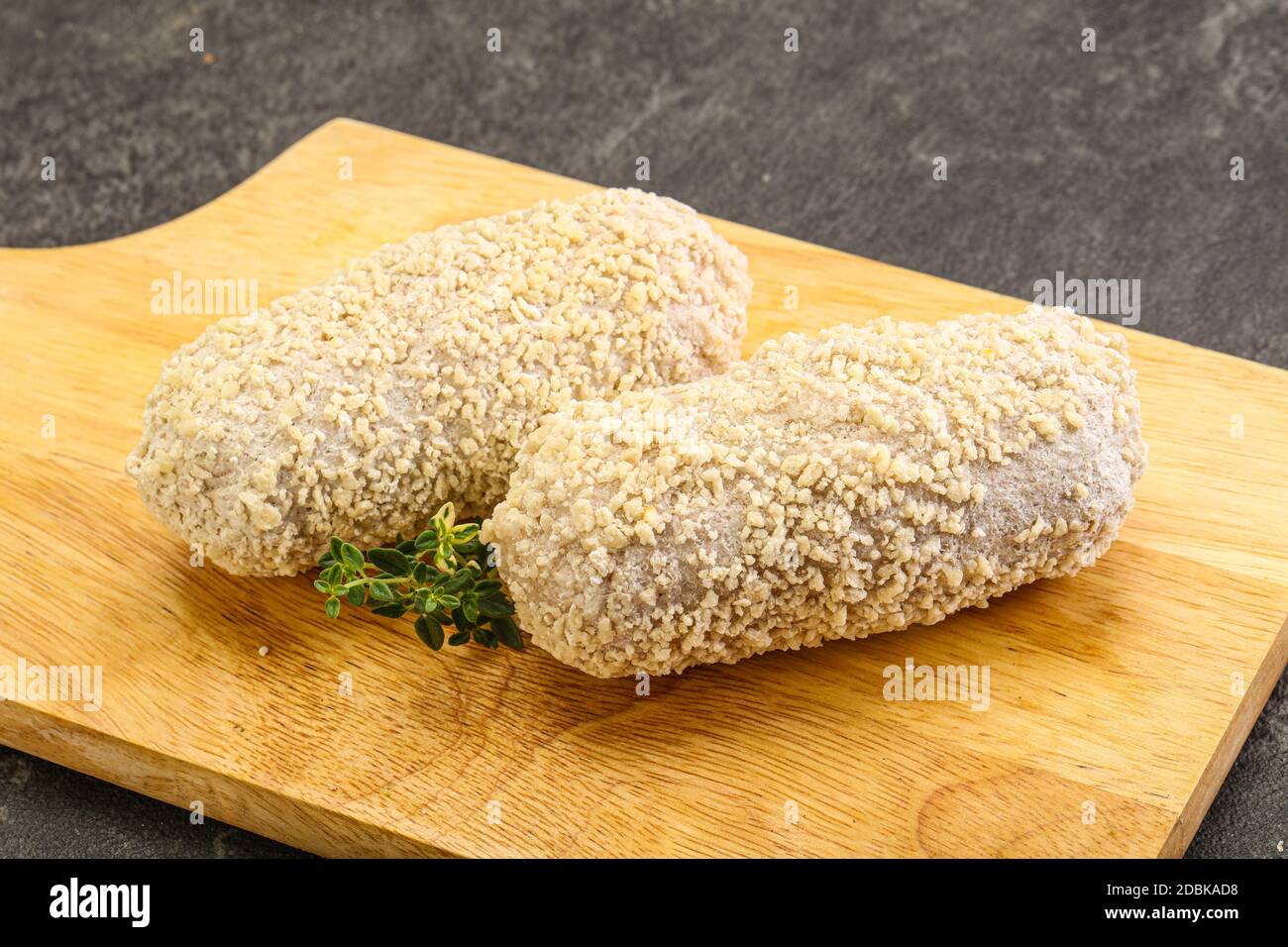 Raw breaded chicken cutlet for roast Stock Photo - Alamy