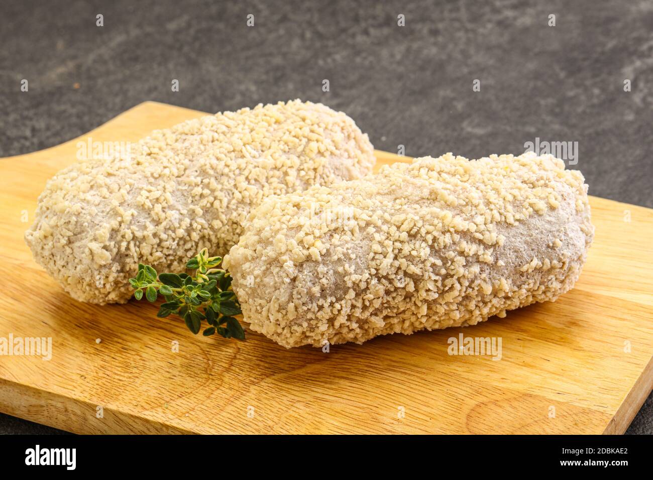 Raw breaded chicken cutlet for roast Stock Photo - Alamy