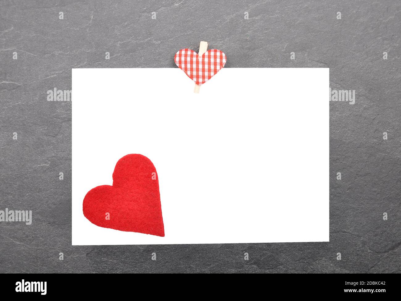 Chit and wooden peg on slate board Stock Photo - Alamy