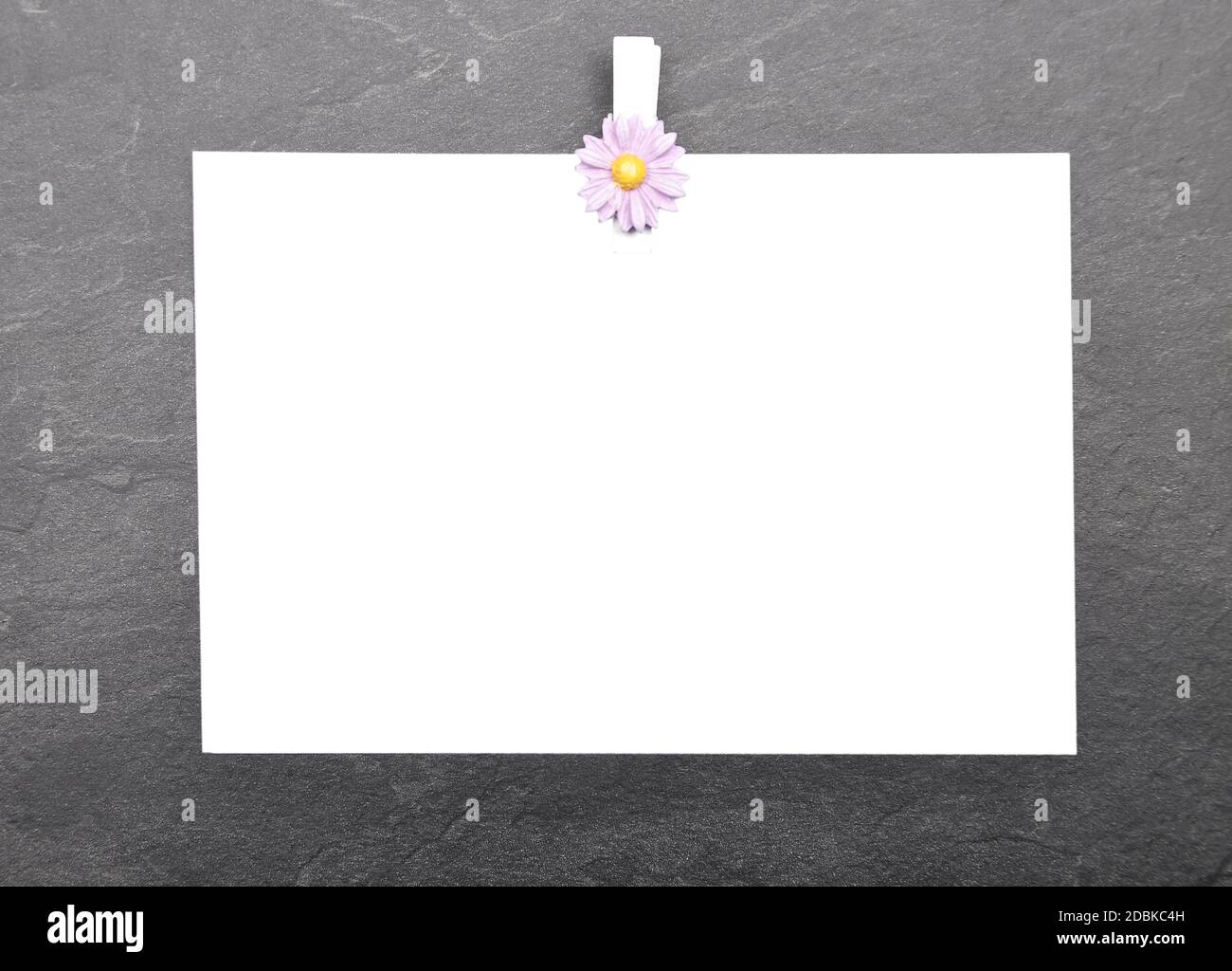 Chit and wooden peg on slate board Stock Photo - Alamy