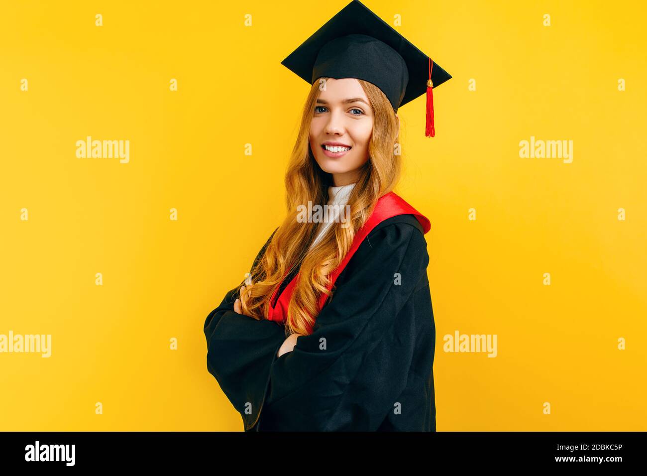 Happy attractive graduate, on a yellow background. Concept of the ...