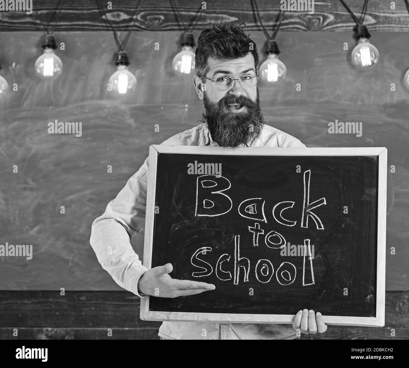 Back to school concept. Man with beard and mustache on cheerful face ...