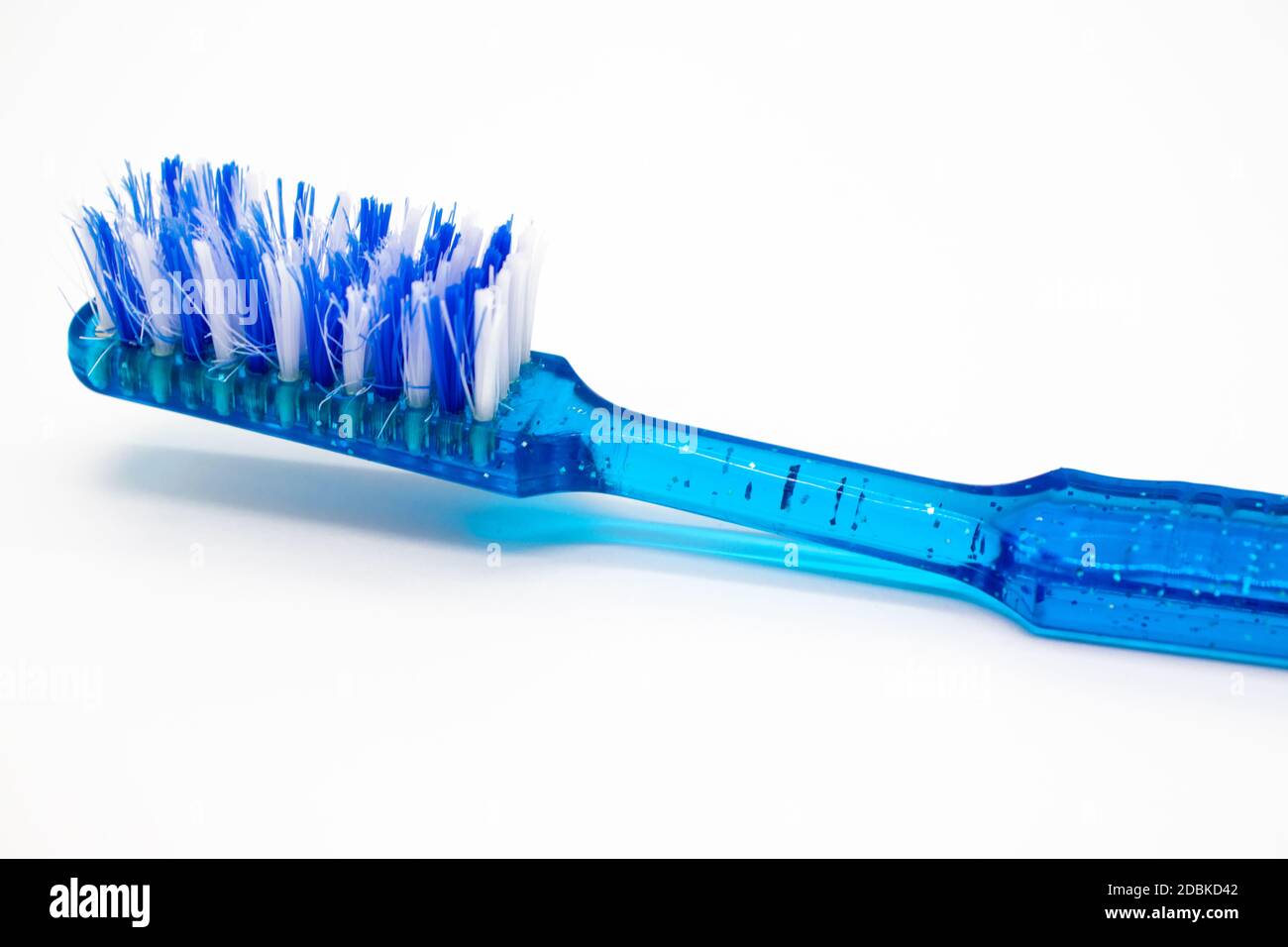 Old blue toothbrush isolated on white background Stock Photo - Alamy
