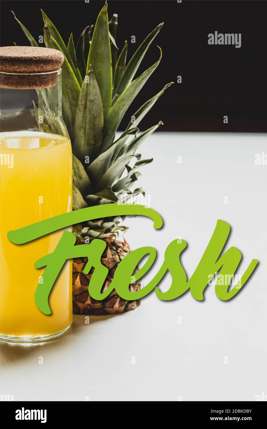 pineapple juice in bottle near delicious fruit and fresh lettering on ...