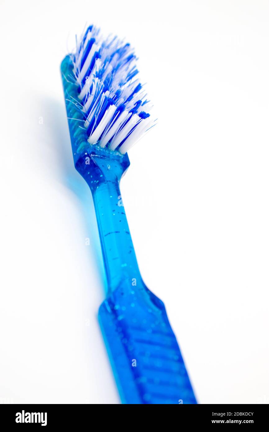 Old blue toothbrush isolated on white background Stock Photo - Alamy
