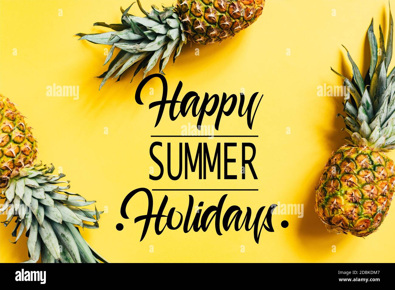top view of fresh tasty pineapples on yellow background with happy ...