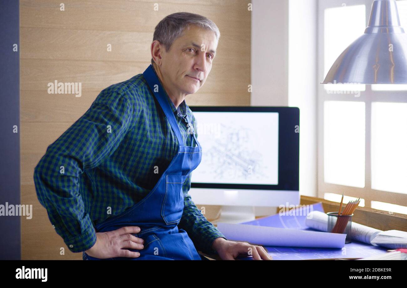Engineer carpenter working on laptop and sketching project Stock Photo ...