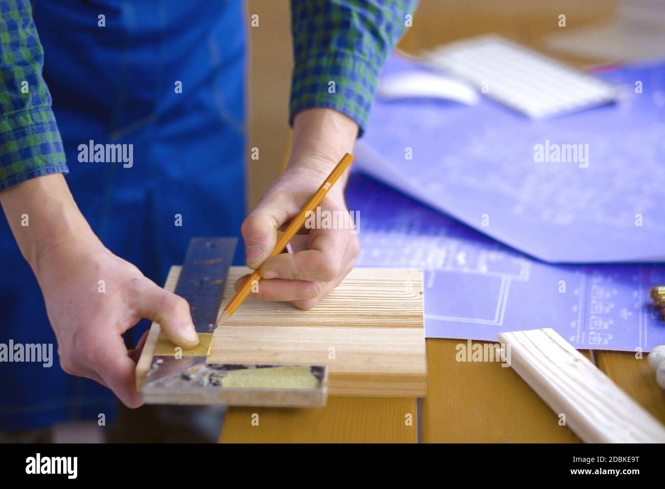 Engineer carpenter working on laptop and sketching project Stock Photo ...