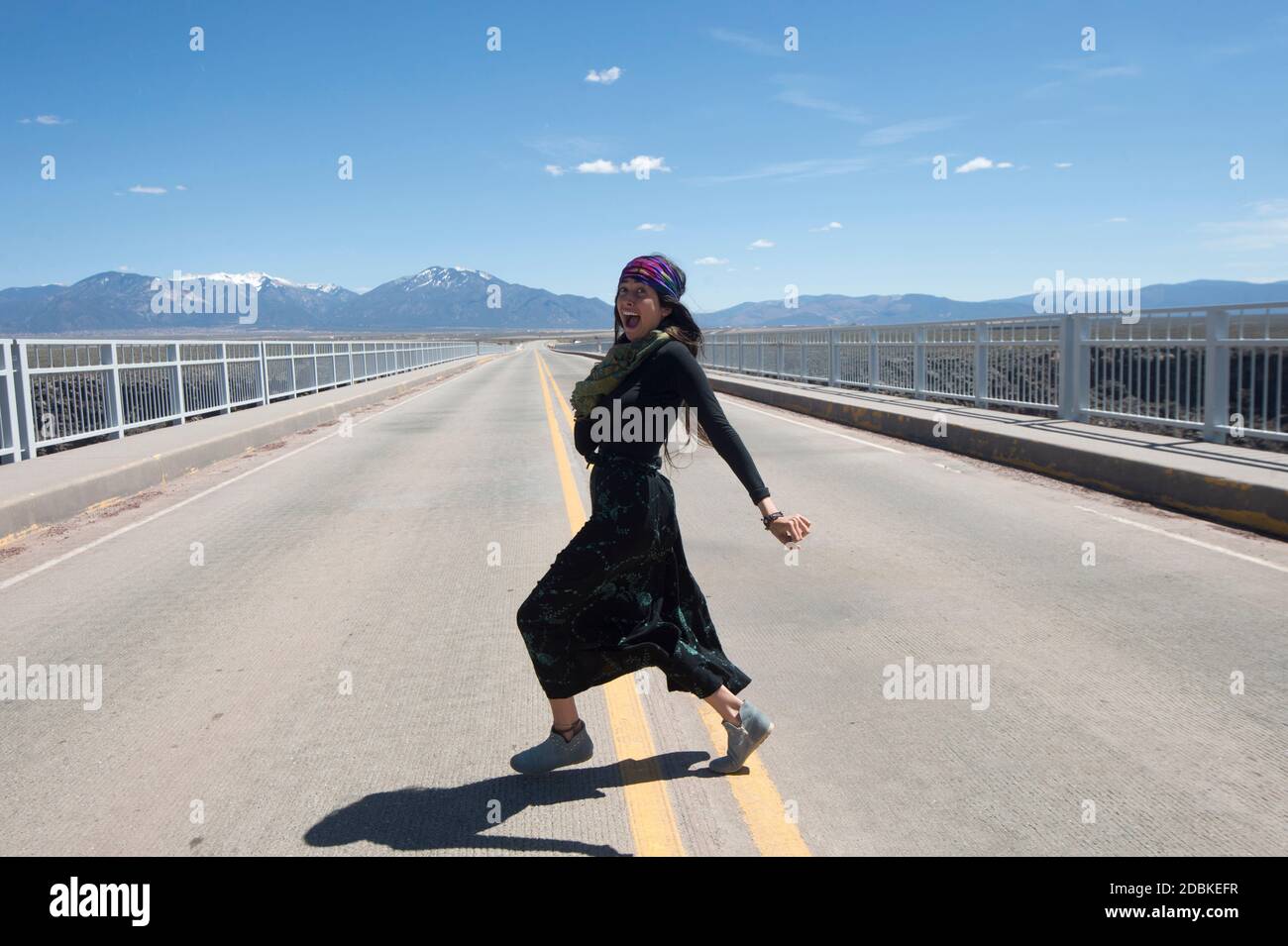 Woman running across road, Taos, New Mexico, USA Stock Photo - Alamy