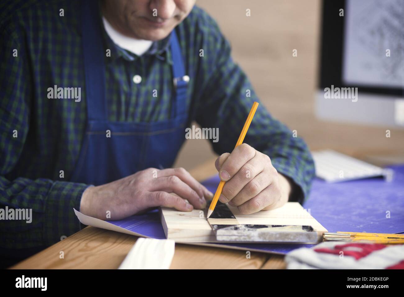 Engineer carpenter working on laptop and sketching project Stock Photo ...