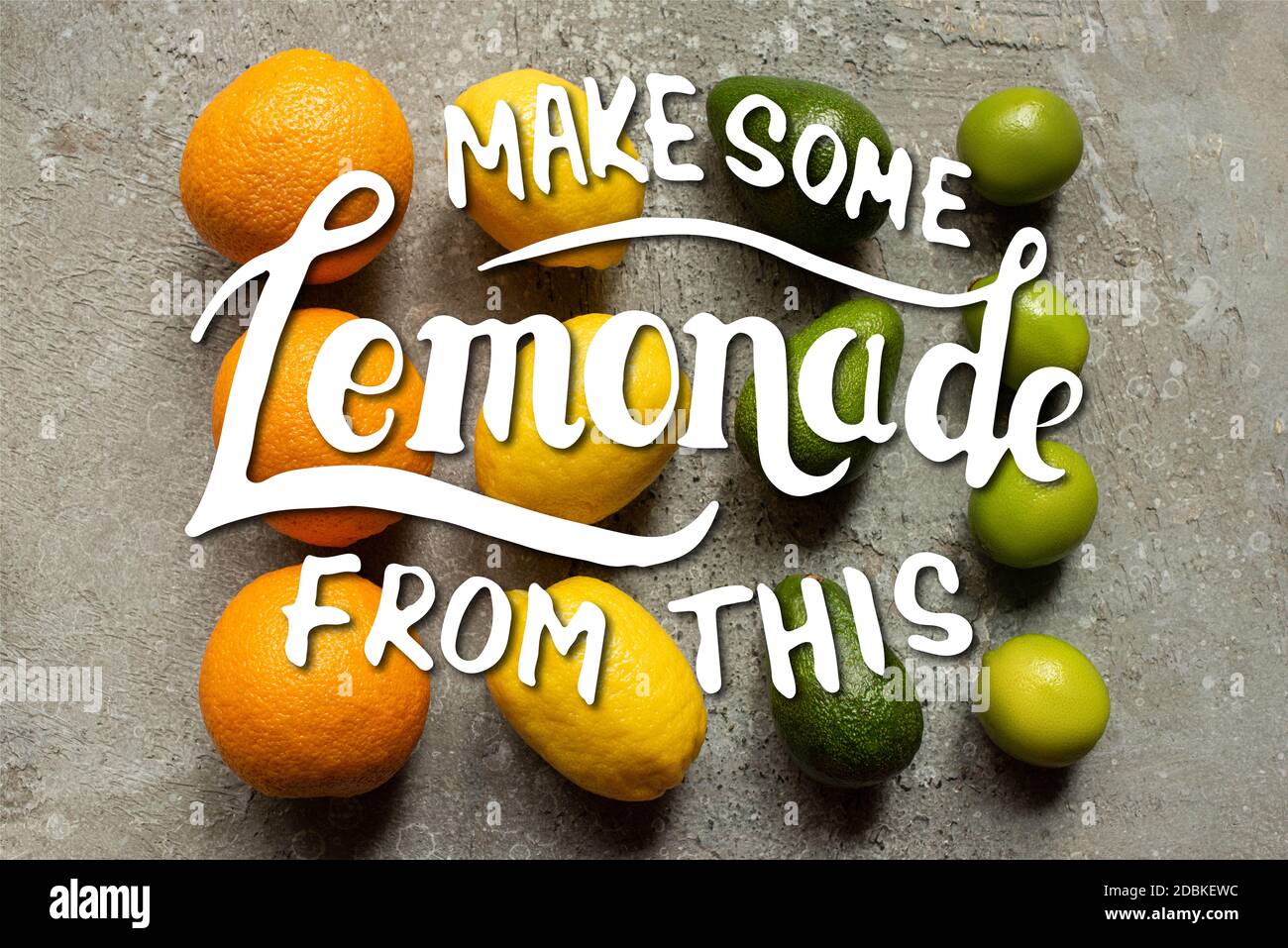 flat lay with colorful oranges, avocado, limes and lemons on grey ...