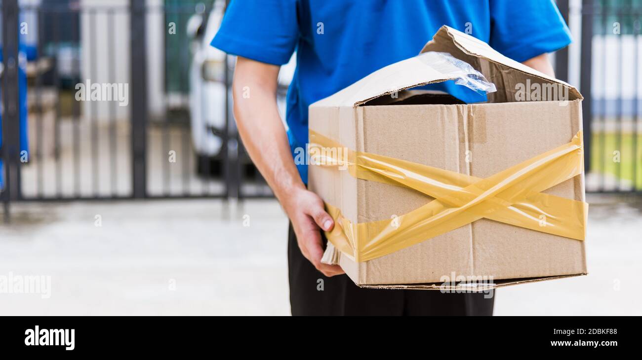 Asian young delivery man in blue uniform he emotional falling courier ...