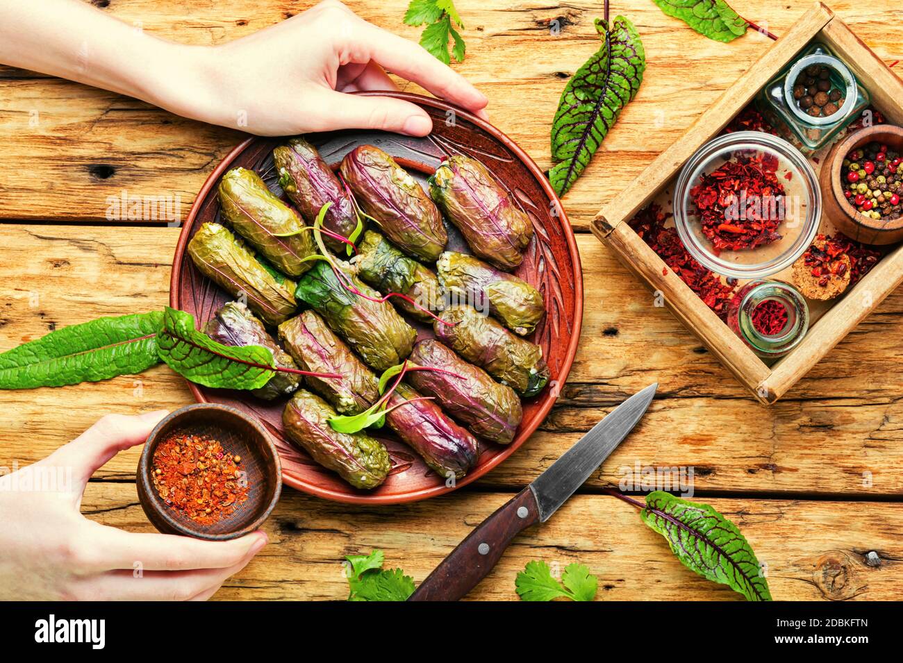Traditional oriental dolma in grape leaves on rustic wooden table Stock ...