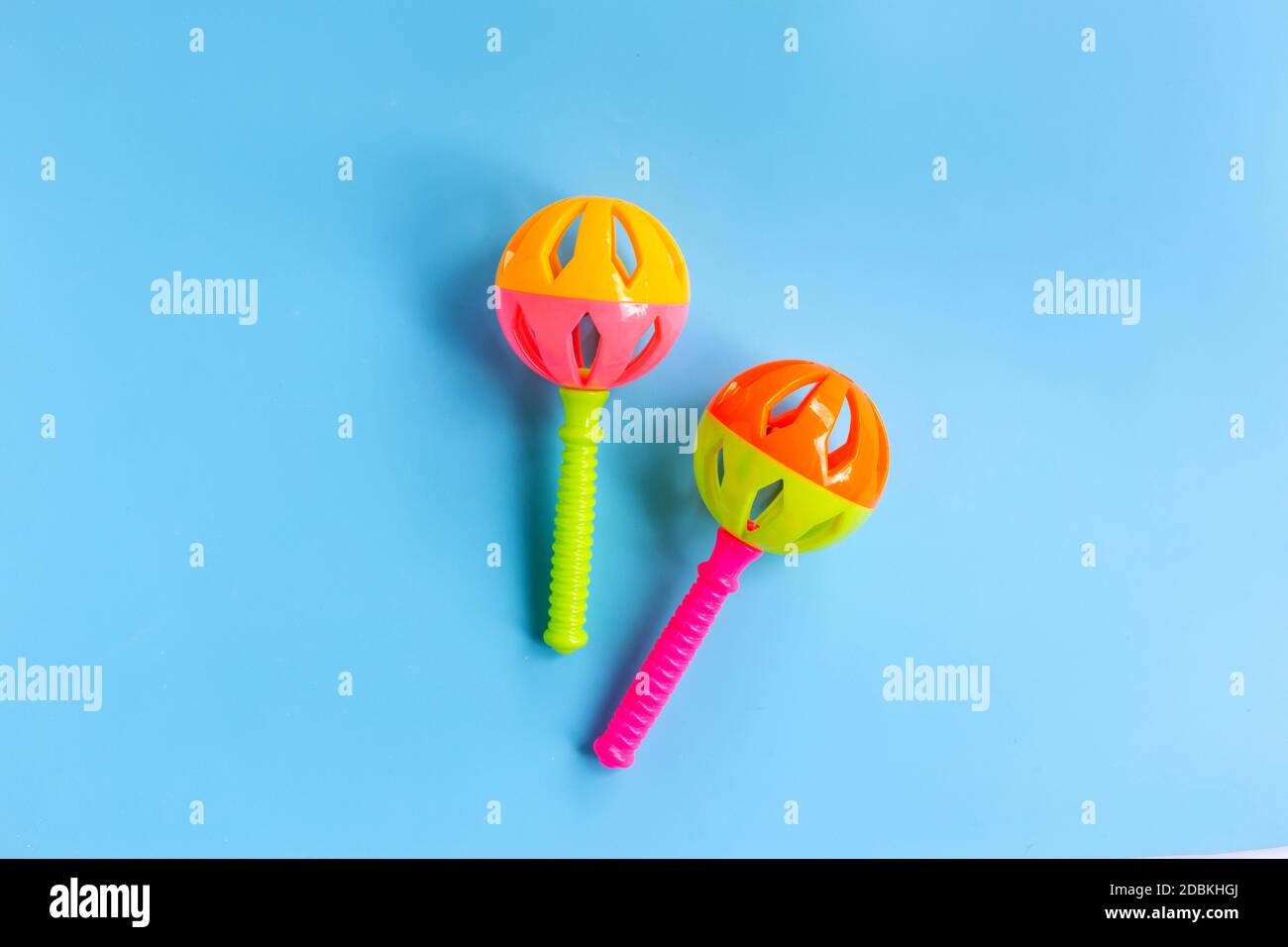 Colorful baby rattle on blue background. Copy space Stock Photo - Alamy