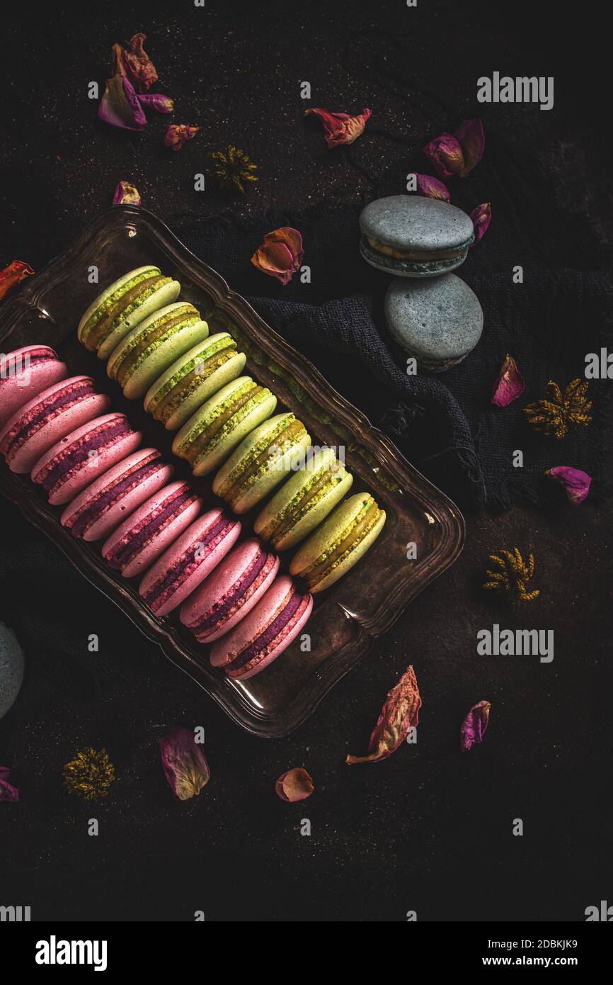 Flat lay of sweet colorful macarons served on vintage tray Stock Photo ...