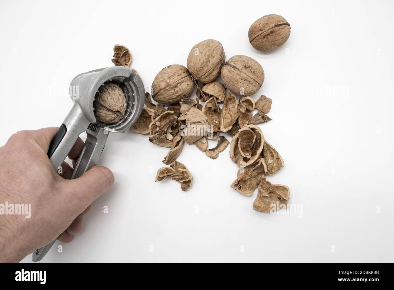 Walnuts on a white background, broken by a nutcracker Stock Photo - Alamy