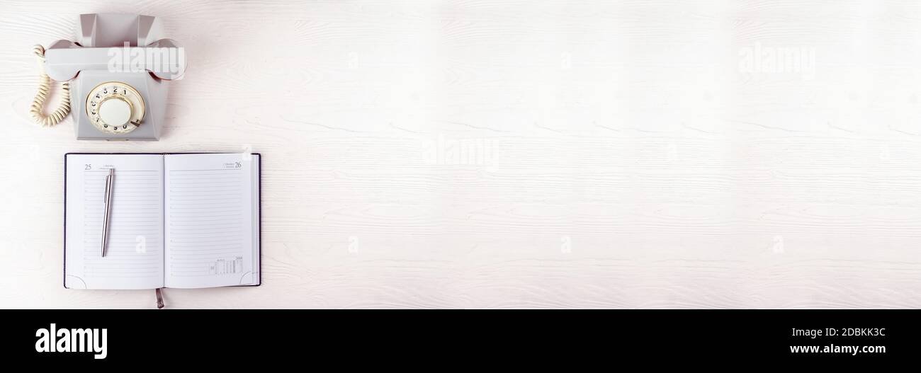 old phone with a notebook on a white background Stock Photo - Alamy