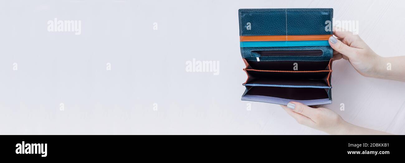 An empty wallet in female hands on white background Stock Photo - Alamy