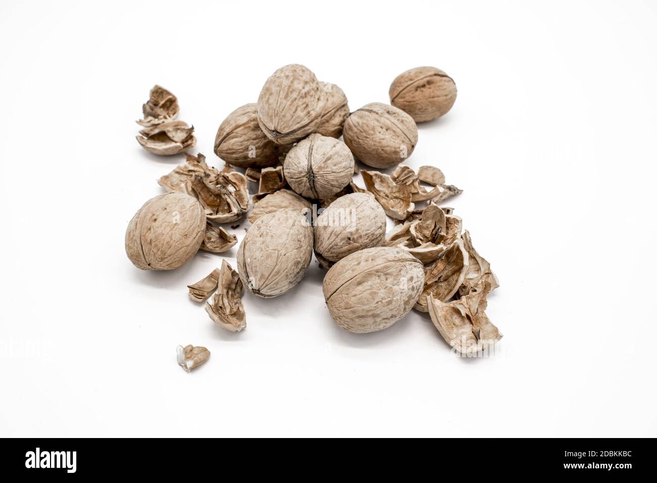 Walnuts on a white background, broken by a nutcracker Stock Photo - Alamy
