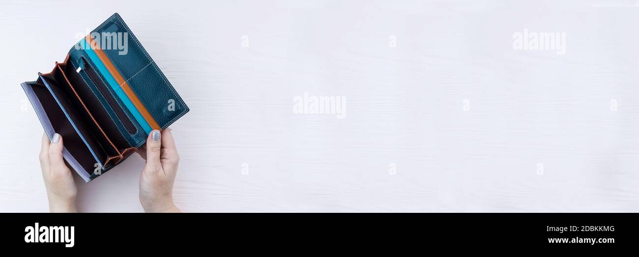 An empty wallet in female hands on white background Stock Photo - Alamy