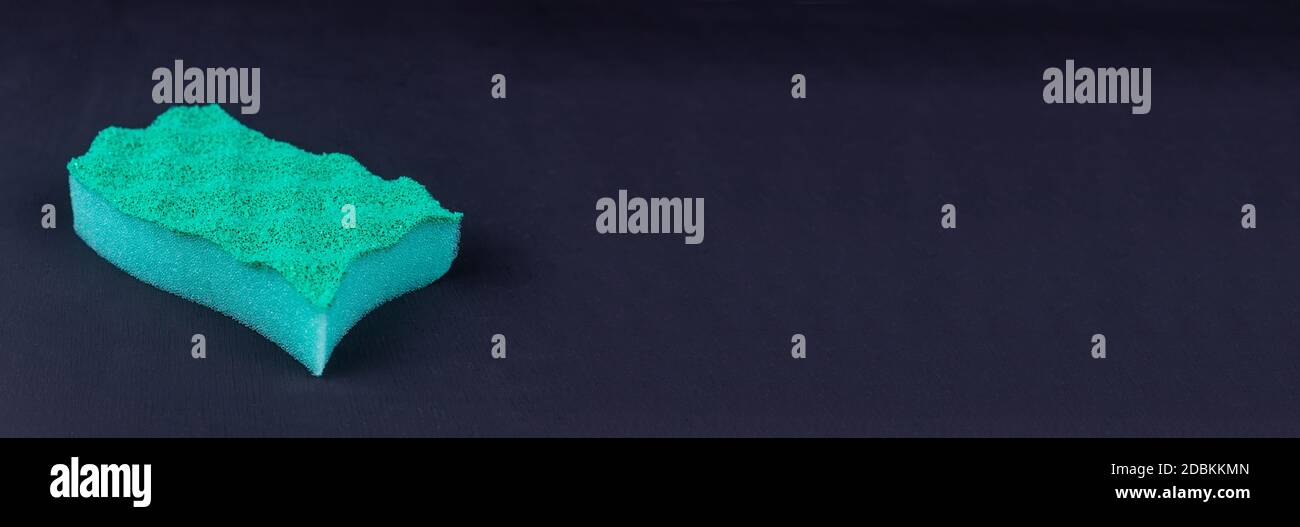 green kitchen sponge on a black background in different poses. Scrub ...