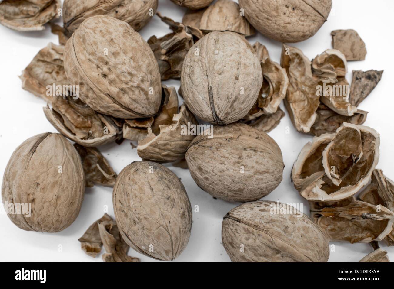 Walnuts on a white background, broken by a nutcracker Stock Photo - Alamy
