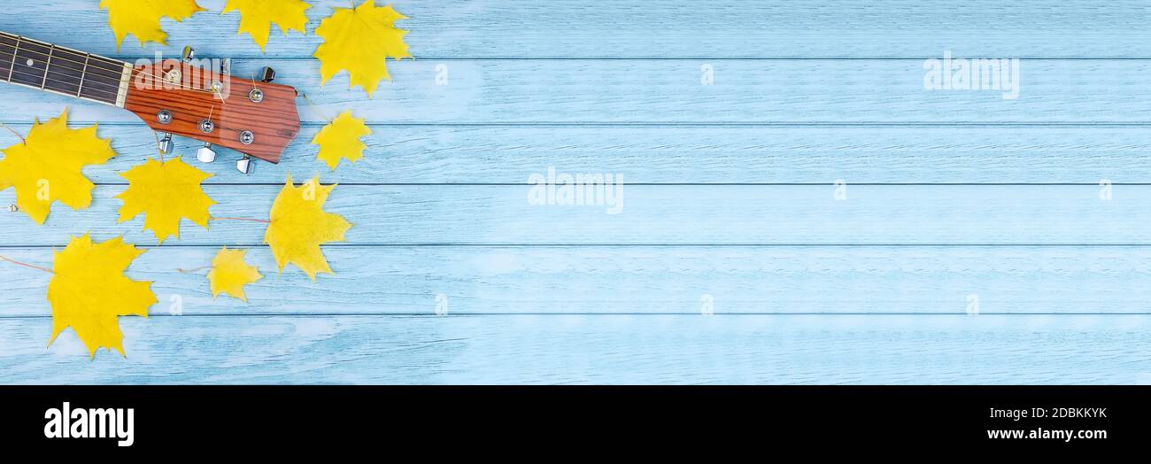 Guitar and autumn leaves maple on a wooden blue background Stock Photo ...