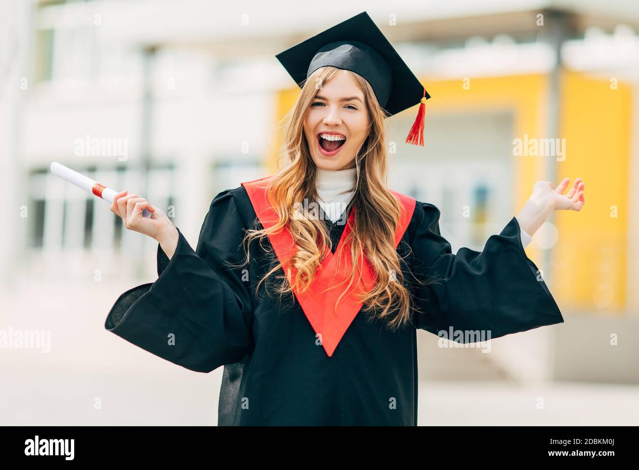 Happy excited beautiful graduate student with a University degree ...