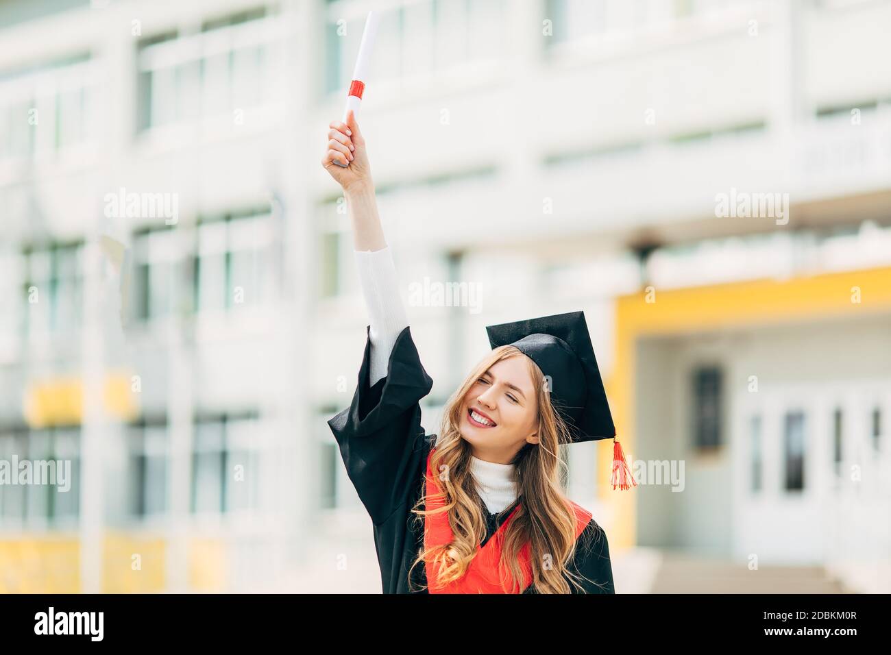 Happy excited beautiful graduate student with a University degree ...