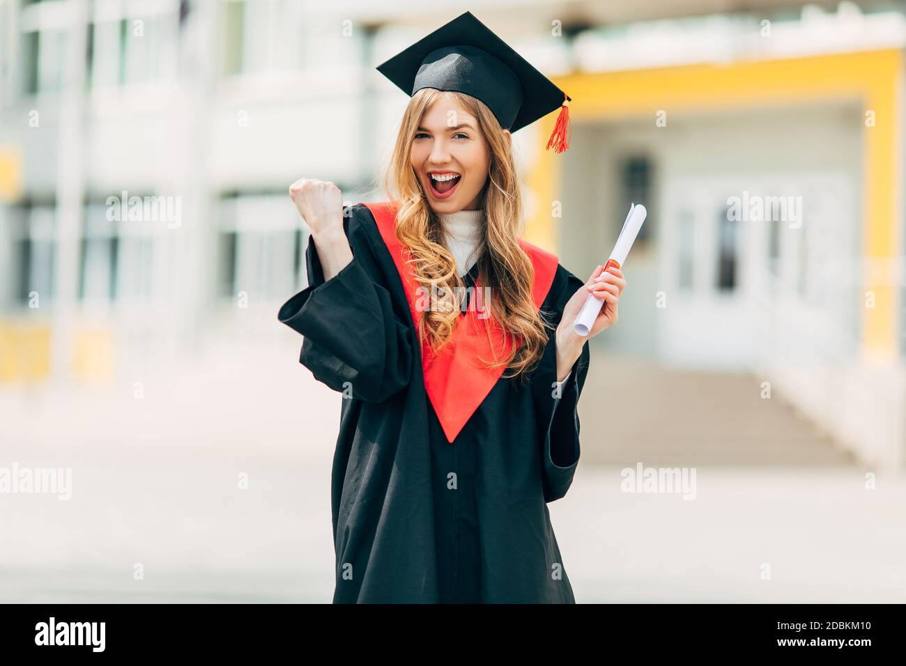Happy excited beautiful graduate student with a University degree ...