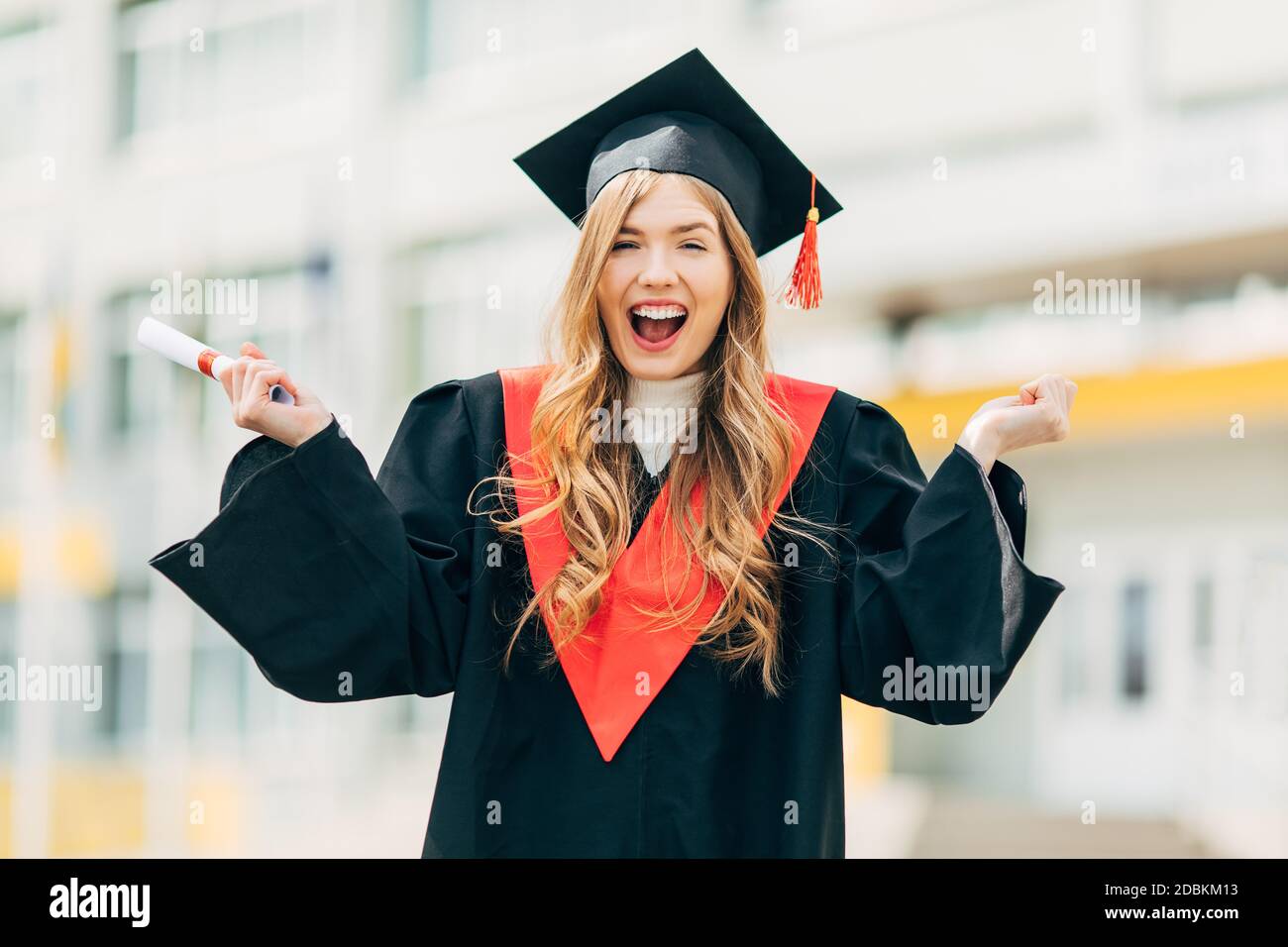 Happy excited beautiful graduate student with a University degree ...
