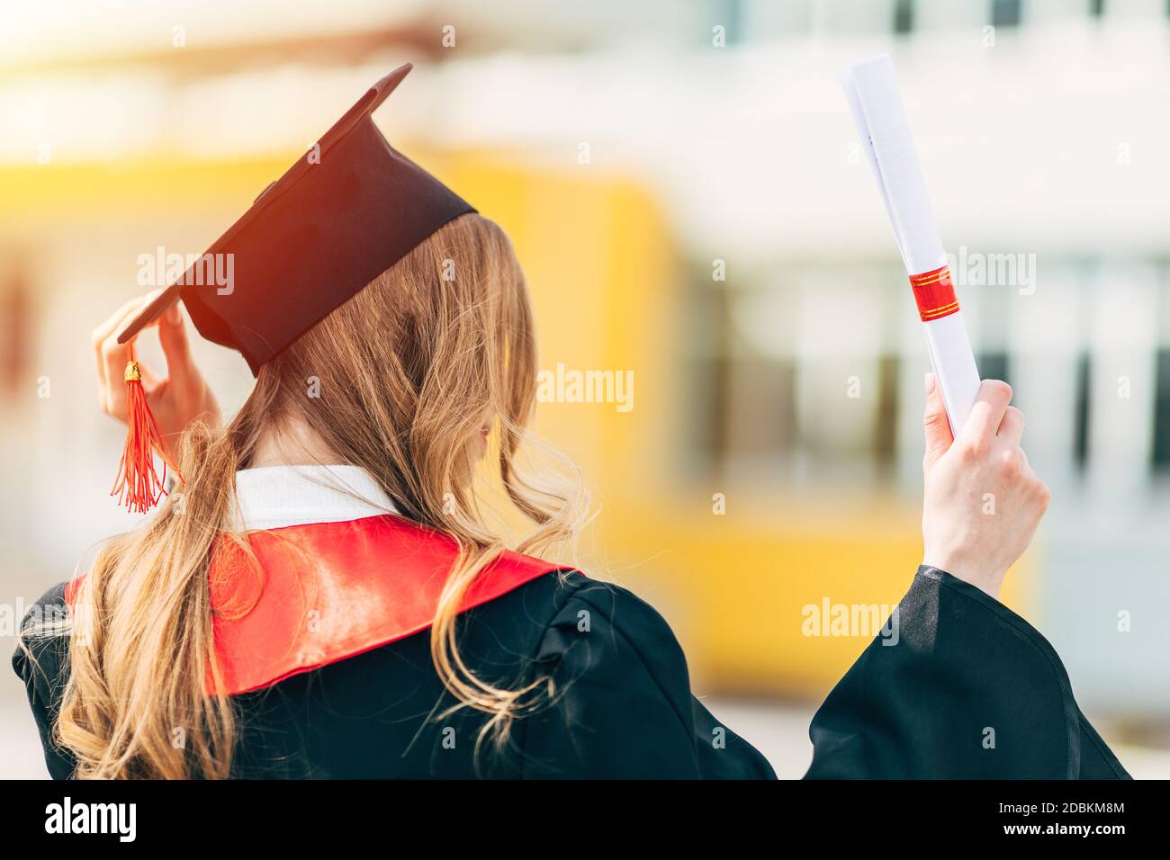Graduation day, back view, a young student in a graduation cap and ...