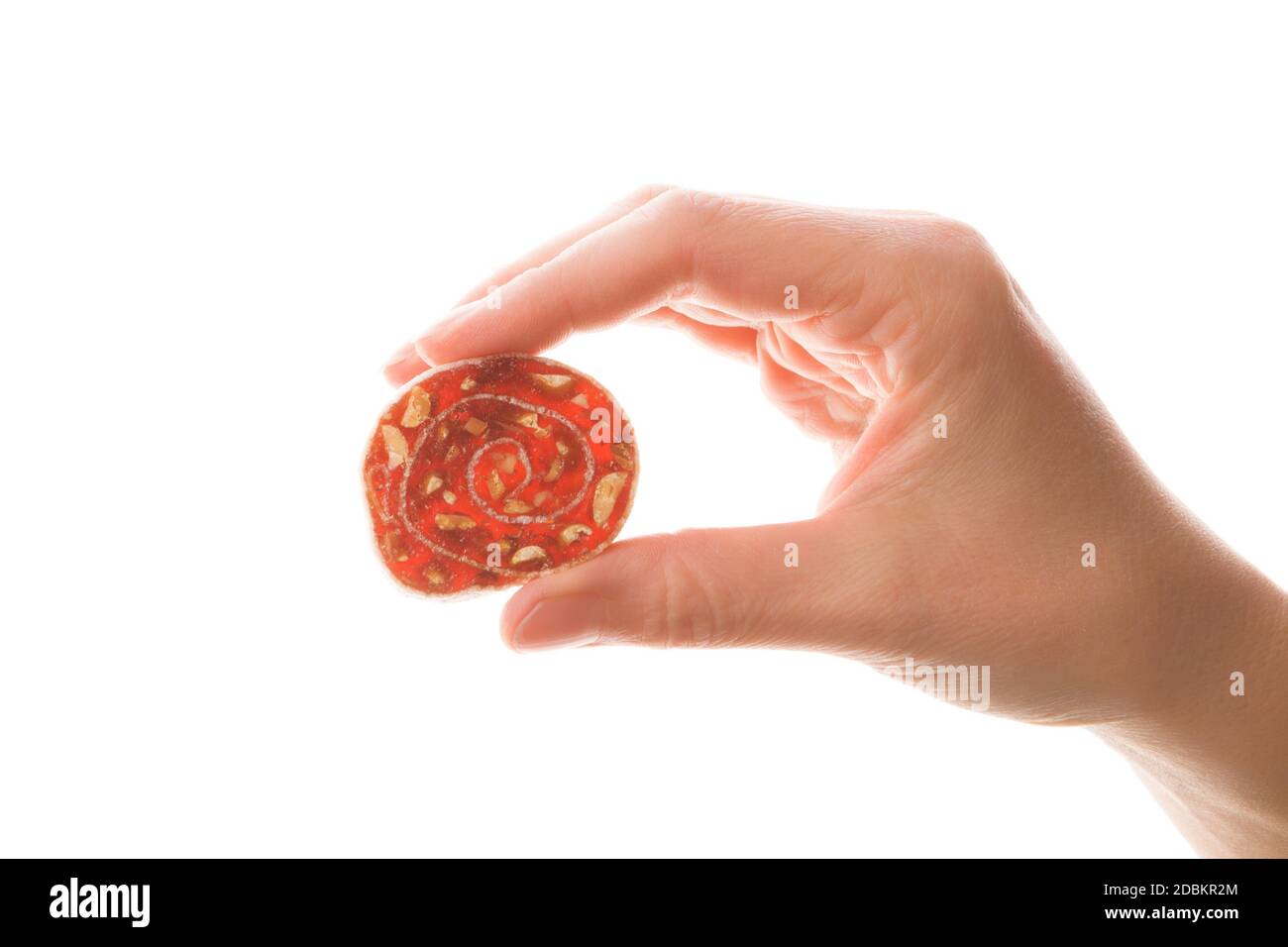 Close up of ginger candy piece in woman hand isolated on white ...