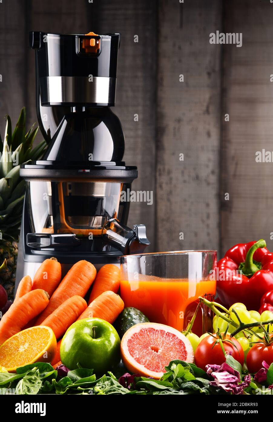 Slow juicer with organic fruits and vegetables. Detox diet Stock Photo ...