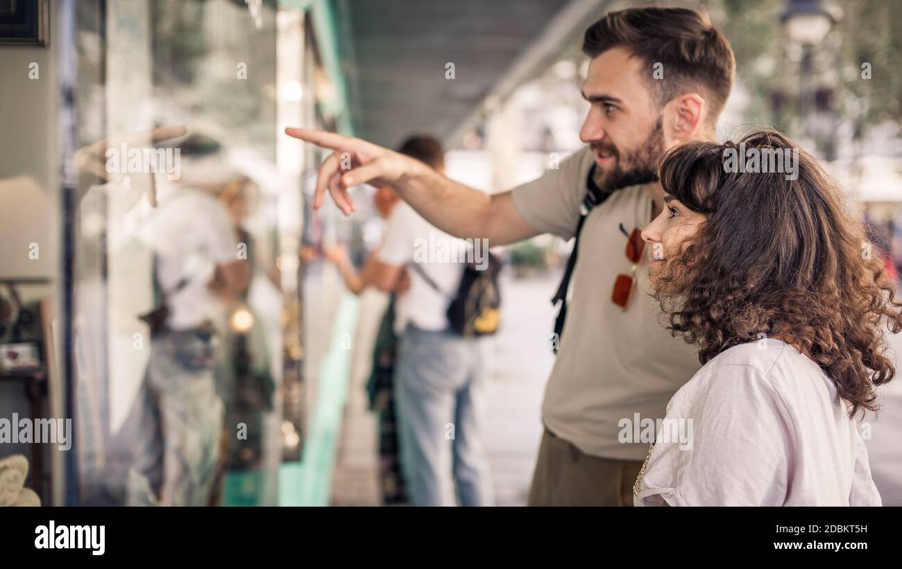 Group of people in shopping mall looking new fashion clothes at shop ...