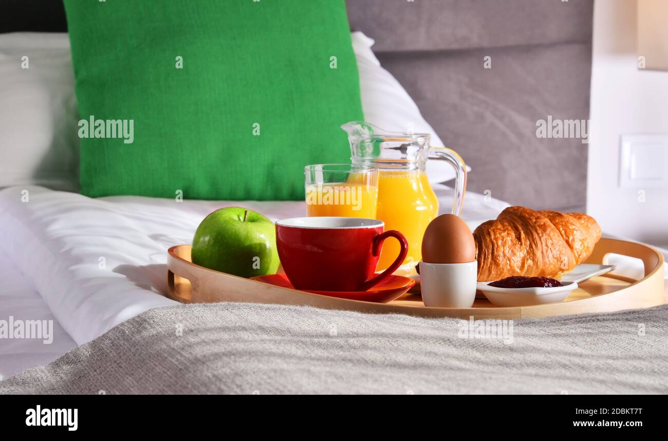 Breakfast on tray in bed in hotel room Stock Photo - Alamy