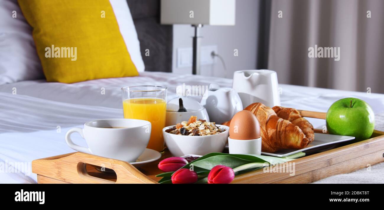 Breakfast on tray in bed in hotel room Stock Photo - Alamy
