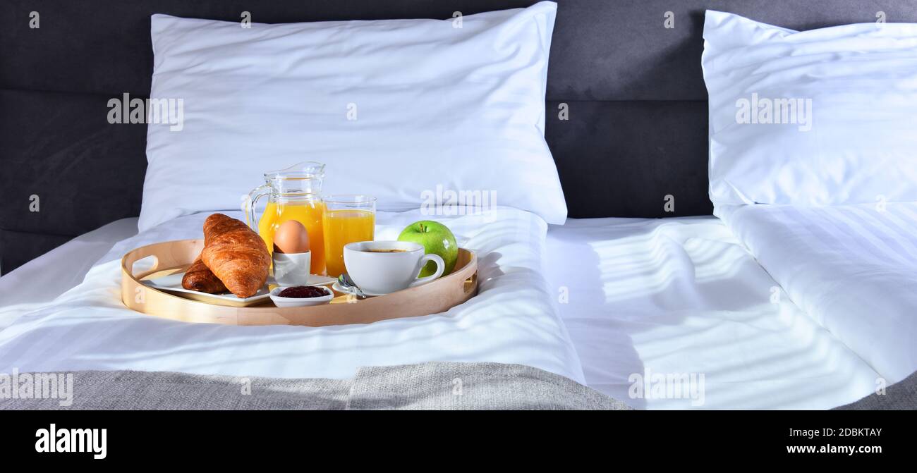 Breakfast on tray in bed in hotel room Stock Photo - Alamy