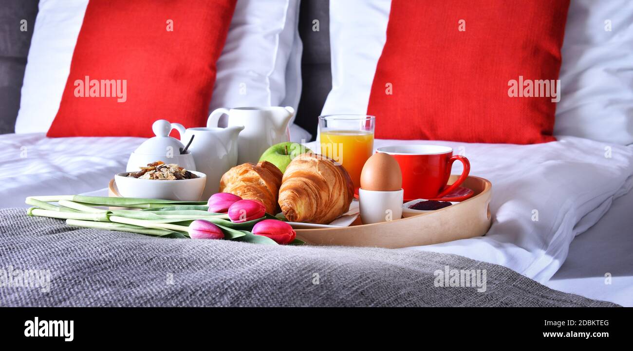 Breakfast on tray in bed in hotel room Stock Photo - Alamy